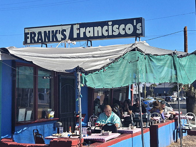 The blue exterior of Frank's/Francisco's isn't just a building&mdash;it's a declaration that fancy isn't always better. Those mismatched tarps? Pure Arizona ingenuity against the desert sun.