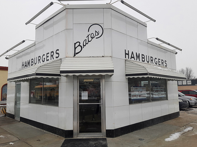 That classic white exterior with striped awning isn't trying to impress anyone, and that's exactly why it works.