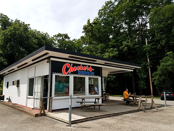 The humble white building with its iconic red cursive "Checkers" sign promises burger perfection without pretension&mdash;a roadside revelation waiting to happen.
