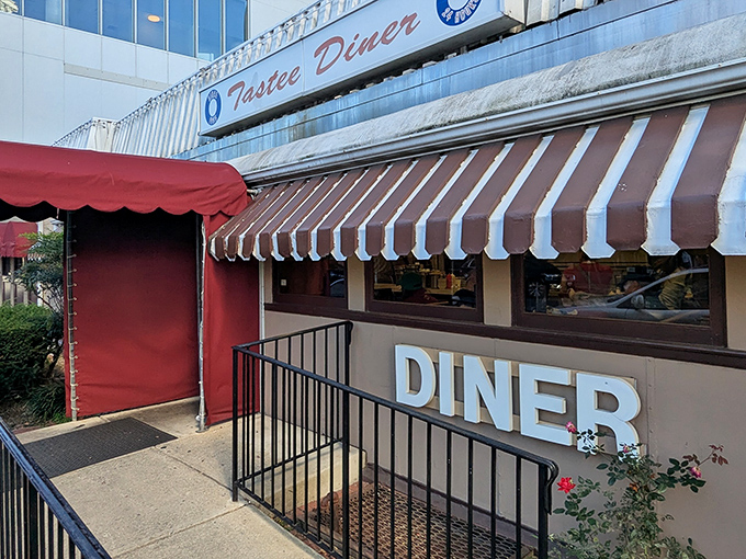 The iconic red and white awning of Tastee Diner beckons like a beacon of breakfast hope on Wisconsin Avenue. Classic Americana at its finest.