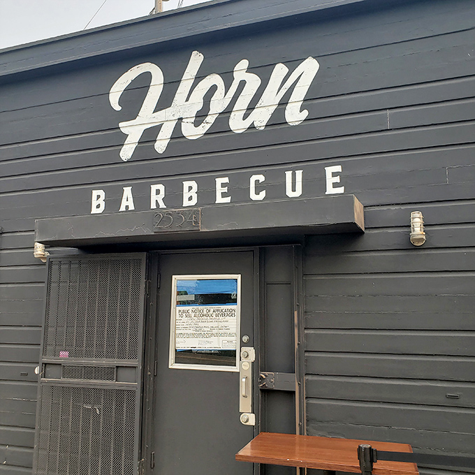 The unassuming black exterior of Horn Barbecue stands like a smoke-scented beacon in Oakland. Simplicity on the outside, magic within.