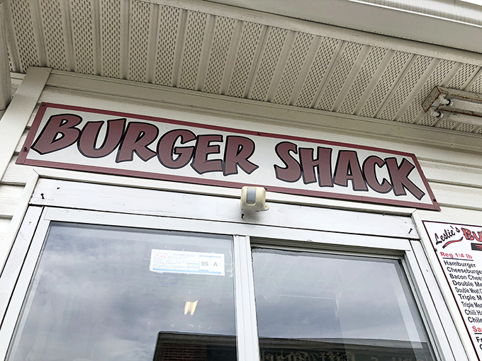 The simple red-and-white sign says it all – no fancy frills needed when the burgers speak volumes for themselves.