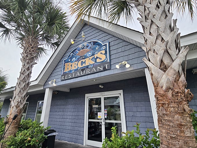The iconic Beck's sign welcomes hungry travelers, framed by palms that have witnessed countless seafood pilgrimages.