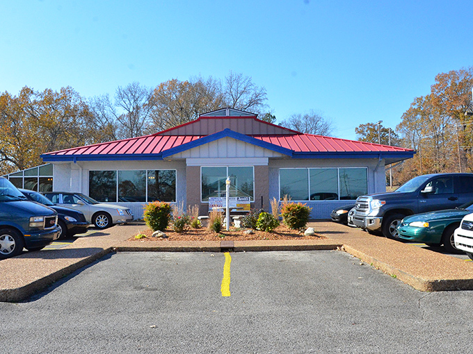 Rustic charm meets Western authenticity with wagon wheels and mounted trophies creating the perfect backdrop for a carnivore's paradise in Paris, Tennessee.