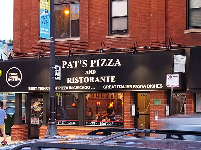 The iconic black awning of Pat's Pizza & Ristorante stands as a beacon of culinary constancy in a sea of trendy Chicago eateries.