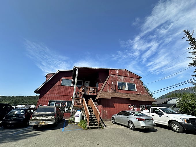 The weathered red exterior of Sandbar & Grill stands like a culinary lighthouse for locals, promising seafood treasures within those humble walls.