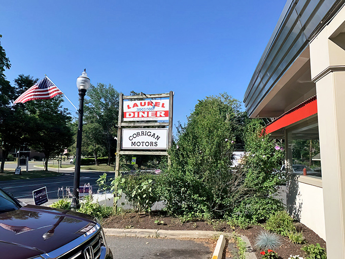 The classic red and white Laurel Diner sign stands proudly against a blue Connecticut sky, promising breakfast bliss just steps away.