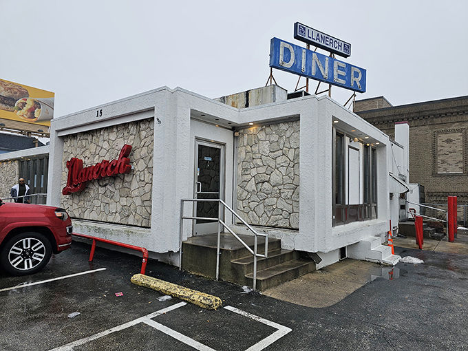 The iconic stone and white exterior of Llanerch Diner, complete with its classic blue sign beckoning hungry patrons to Pennsylvania's breakfast paradise.