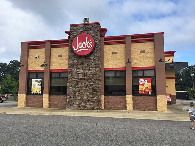 The iconic stone tower and bold red signage of Jack's in Eufaula stands like a beacon of comfort food promise against the Alabama sky.