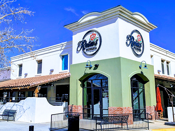 The mint-green and white exterior of Rosa's Pizzeria stands like a beacon of hope for the hungry in Prescott Valley. Pizza paradise awaits!