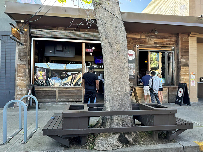 The unassuming wooden exterior of Smokin Woods BBQ beckons Oakland's barbecue pilgrims, where that intoxicating aroma begins its siren call.