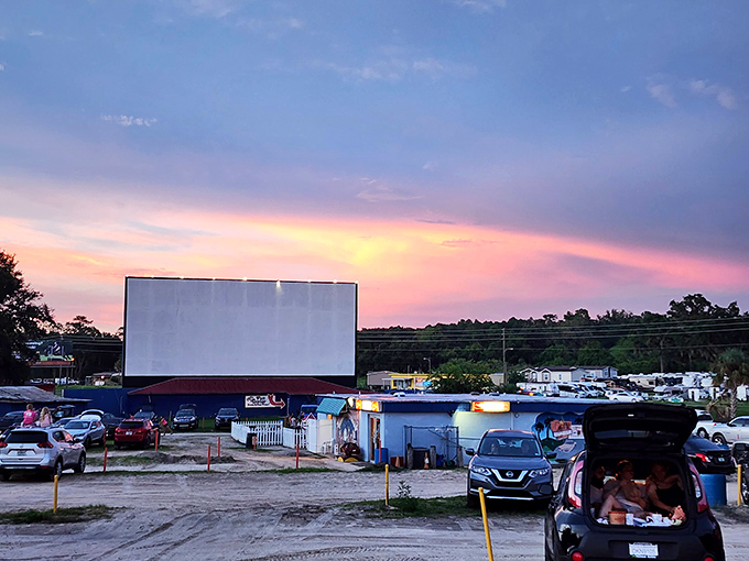 Sunset magic transforms the Ocala Drive-In into a painting come to life, where modern cars gather beneath an ancient ritual of storytelling under the stars.