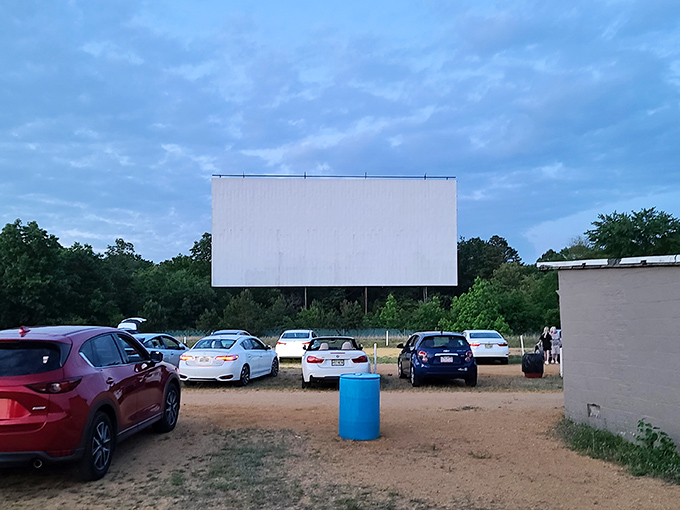 Cars lined up facing the massive white screen at dusk, where memories are made under New Jersey skies. The perfect summer night awaits.