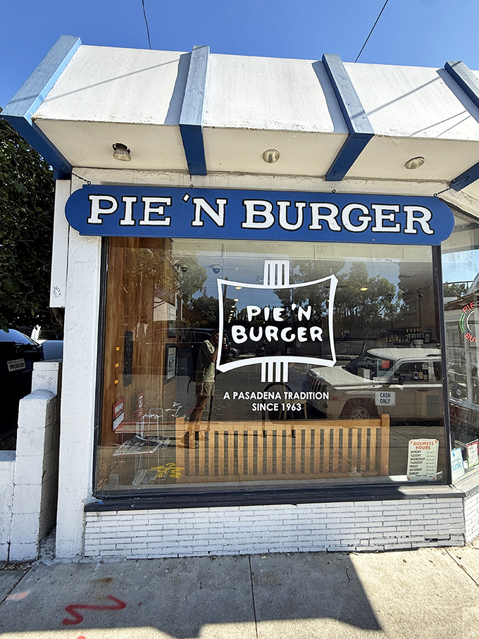 The unassuming storefront of Pie 'n Burger stands like a time capsule on California Boulevard, its vintage blue sign promising simple pleasures that never go out of style.