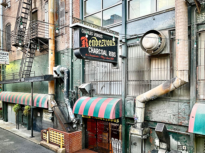 The alleyway entrance to barbecue paradise. Those distinctive green and red awnings have guided hungry pilgrims to Memphis' rib sanctuary for generations.