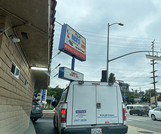 Rick's iconic exterior stands like a time capsule of California burger culture, the blue awning beckoning hungry travelers like a culinary lighthouse.