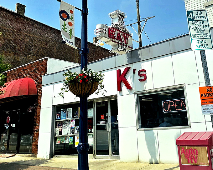 The neon "EAT" sign beckons like a lighthouse for hungry souls. K's white-tiled exterior hasn't changed because perfection needs no updates.