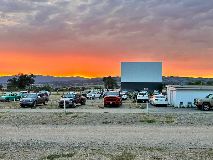 Mother Nature's pre-show spectacle outshines any Hollywood special effects as cars gather beneath a cotton candy sky. Pure Utah magic.