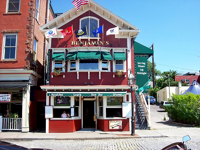 Benjamin's red exterior stands like a maritime beacon on Thames Street, promising seafood treasures within its historic walls.