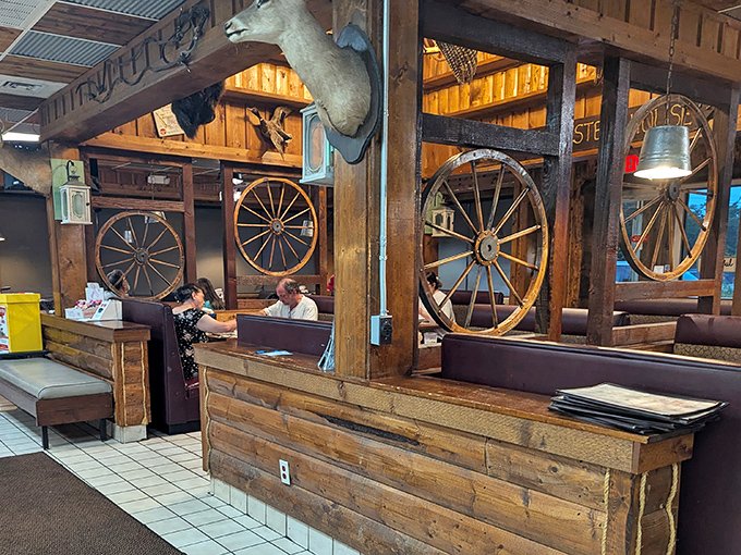 Rustic charm meets Western authenticity with wagon wheels and mounted trophies creating the perfect backdrop for a carnivore's paradise in Paris, Tennessee.