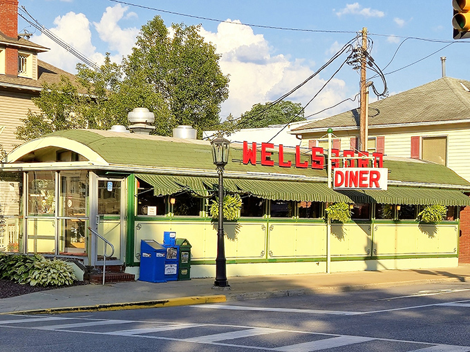 The classic green and cream exterior of Wellsboro Diner beckons like a time machine disguised as a lunch counter. That vintage sign isn't kidding around.