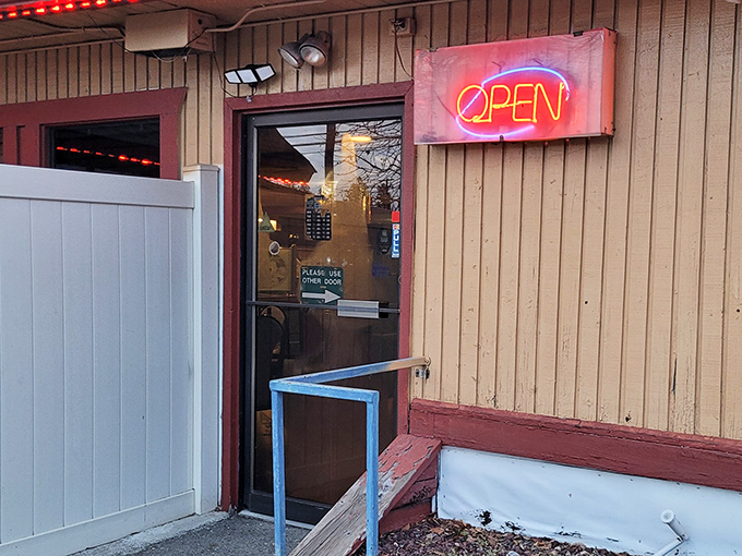 The unassuming entrance with its glowing neon "OPEN" sign – proof that culinary treasures often hide in plain sight.