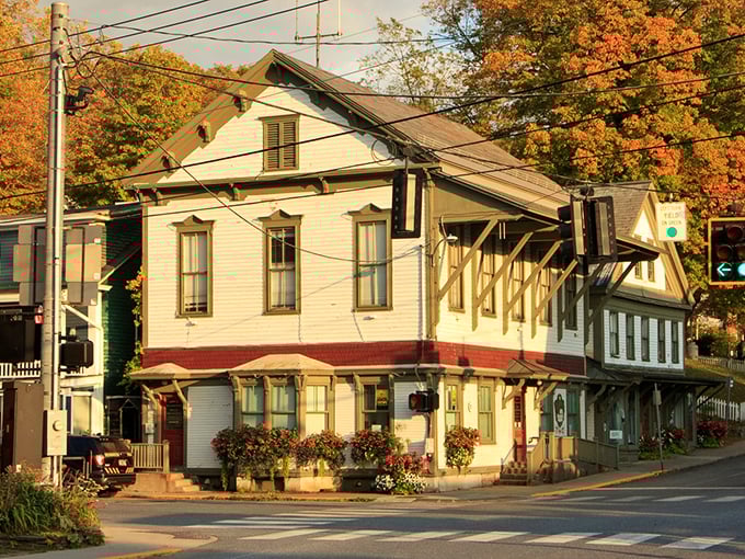 Dot's Restaurant stands like a sentinel of comfort food beneath Vermont's autumn canopy. The iconic neon sign has welcomed hungry travelers for generations.
