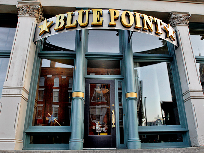 The iconic Blue Point Grille entrance beckons seafood lovers with its elegant gold lettering and distinctive blue-trimmed façade – Cleveland's gateway to oceanic bliss.