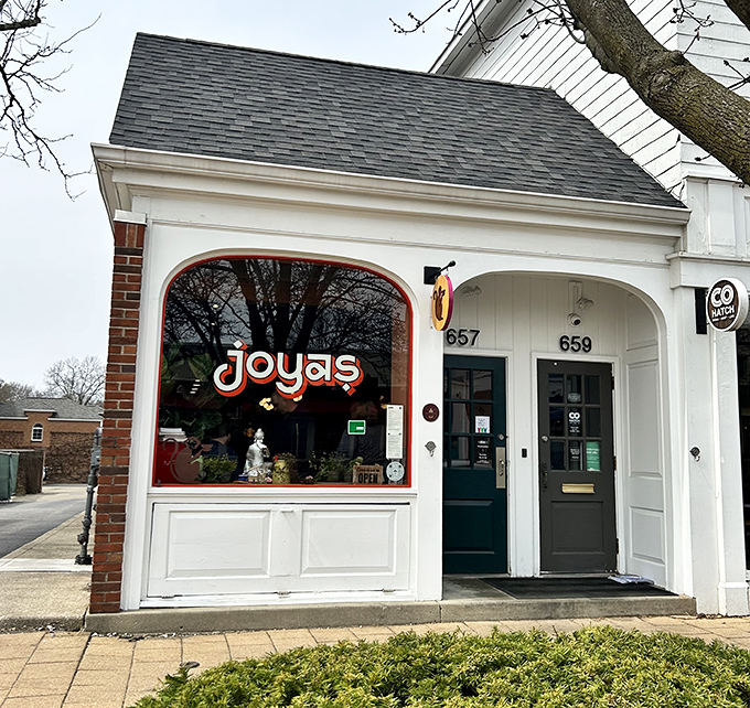 Joya's charming brick exterior beckons like a culinary lighthouse in Worthington's historic district. That red logo promises delicious adventures await.