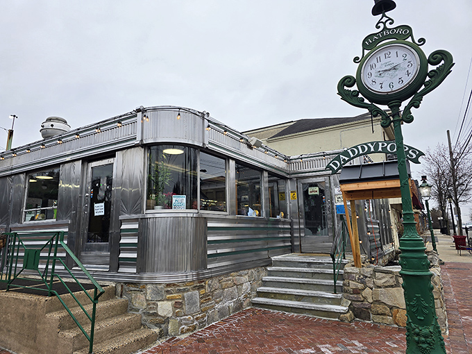 The classic stainless steel exterior of Daddypops gleams like a beacon of breakfast hope on York Road, complete with that iconic vintage green clock.
