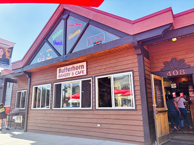 The wooden facade of Butterhorn Bakery & Cafe beckons like a cozy cabin promising breakfast nirvana, complete with that glowing "OPEN" sign that feels like permission to indulge.