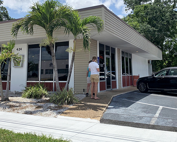 The unassuming mid-century facade of Beefy King stands like a time capsule on Bumby Avenue, palm trees standing guard over decades of sandwich perfection.