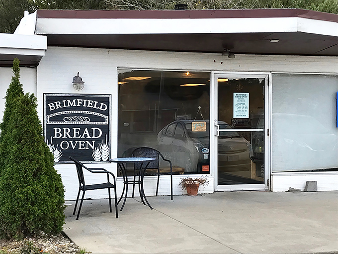 The unassuming white farmhouse exterior hides culinary magic within. Like finding Narnia in your neighborhood, but with better carbs.