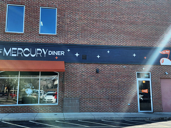 The Mercury Diner's brick exterior with its signature orange awning stands like a beacon for hungry travelers in Columbus's Old North neighborhood.