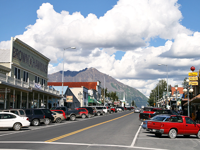 The quintessential Alaskan small town scene: historic buildings nestled at the foot of mountains so majestic they make skyscrapers seem like an unnecessary human flex.