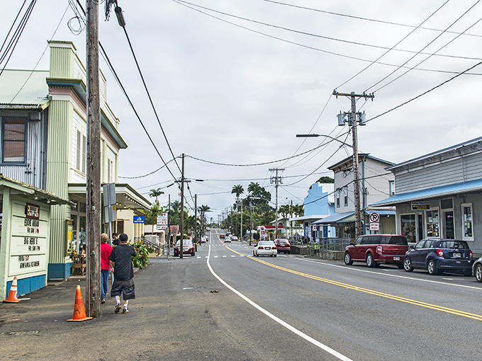 Downtown Honokaa whispers stories of plantation days past, while locals stroll unhurried beneath power lines that have witnessed decades of island life.