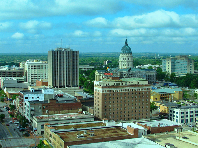 Downtown Topeka stretches out under a perfect Kansas sky, where historic buildings stand shoulder-to-shoulder with modern life like old friends catching up.