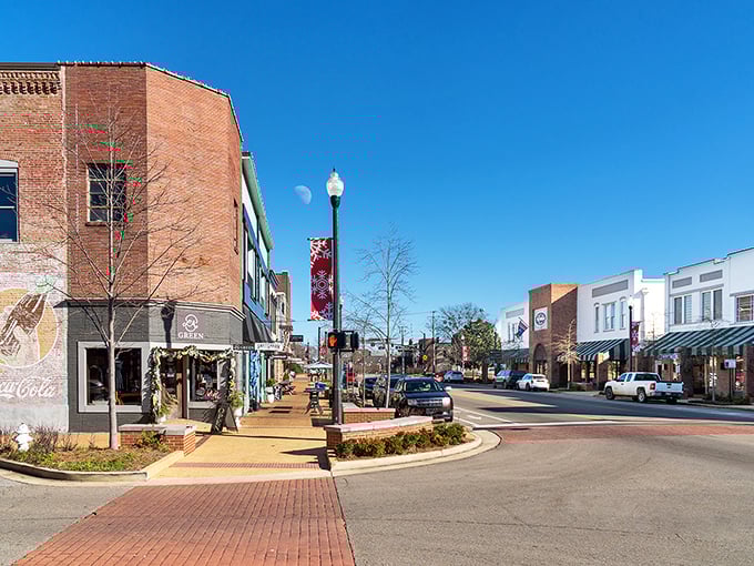 Downtown Tupelo's historic charm comes alive under clear blue skies, where brick buildings and festive banners create the perfect small-town backdrop for your weekend wanderings.