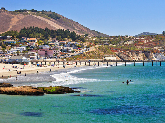 Where the mountains meet the sea in perfect harmony. Surfers dot the crystalline waters while beachgoers soak up that famous Central Coast sunshine.