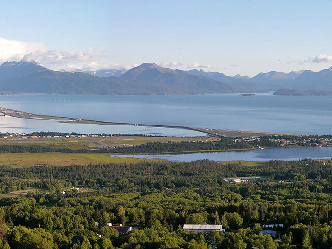 The Homer Spit stretches into Kachemak Bay like nature's own welcome mat, with mountains standing guard across the water.
