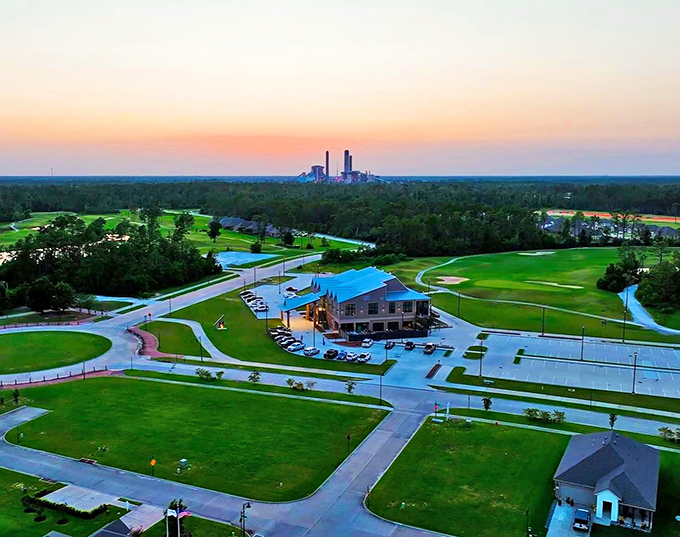 Sunset perfection at The National Golf Club of Louisiana, where retirement dreams come with fairway views and industrial skylines that somehow work together beautifully.