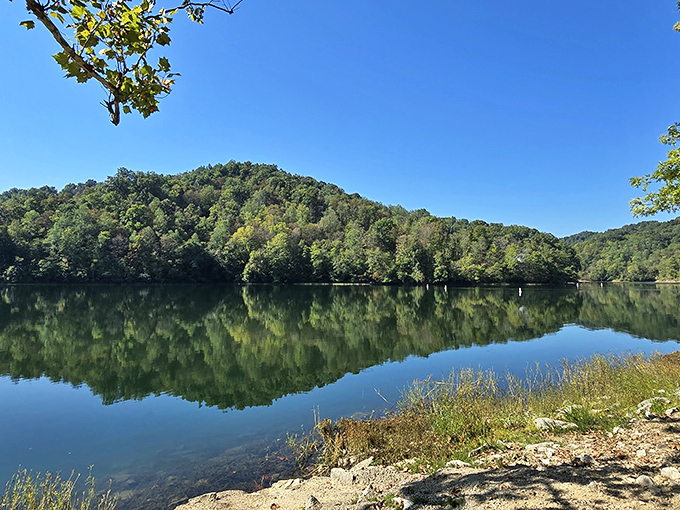 Mirror, mirror on the water &ndash; Paintsville Lake's glass-like surface perfectly doubles the surrounding Appalachian hills, creating nature's own infinity pool.