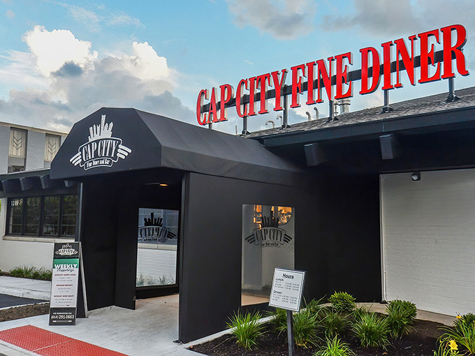 The iconic red Cap City sign glows like a beacon for hungry souls, promising comfort food with a sophisticated twist in Columbus.