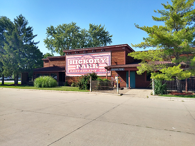 The wooden fortress of flavor beckons from the roadside, promising smoked meat treasures within its rustic walls.