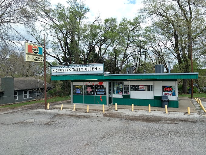 The unassuming turquoise fortress of flavor stands proudly along the roadside, a time capsule of American drive-in culture that promises delicious nostalgia with every visit.