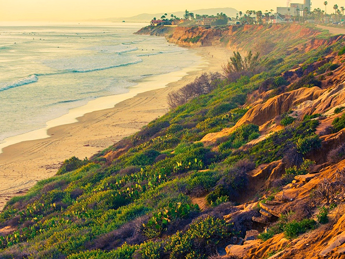 Nature's own watercolor masterpiece &ndash; Terramar's golden cliffs catch the sunset light while gentle waves create a rhythm only California's coast can compose.