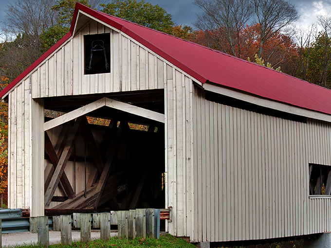 The classic white clapboard and red roof combination makes this bridge look like it's dressed for a historical costume party every day of the year.