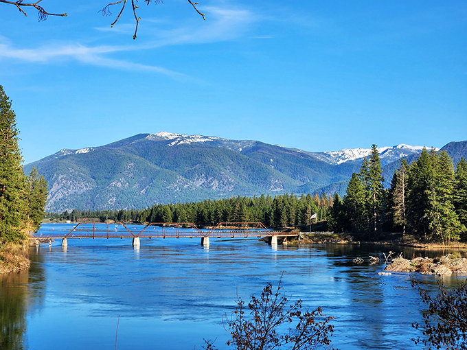 Mother Nature's masterpiece unfolds where crystal waters meet towering mountains, creating a postcard-perfect Montana moment that no filter could improve.