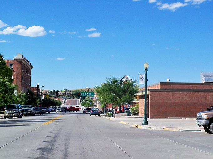 Main Street Lusk stretches toward the horizon like a scene from a Norman Rockwell painting, where brick buildings and blue skies create the perfect small-town tableau.