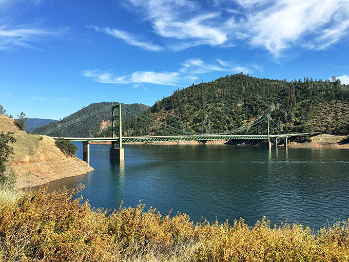 The Bidwell Bar Bridge stretches across emerald waters like Northern California's answer to a scenic postcard you actually want to send.